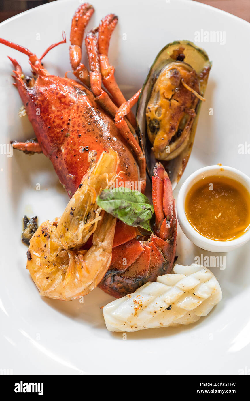 Grilled Halved Lobster Tails with mussel and calamari Stock Photo - Alamy