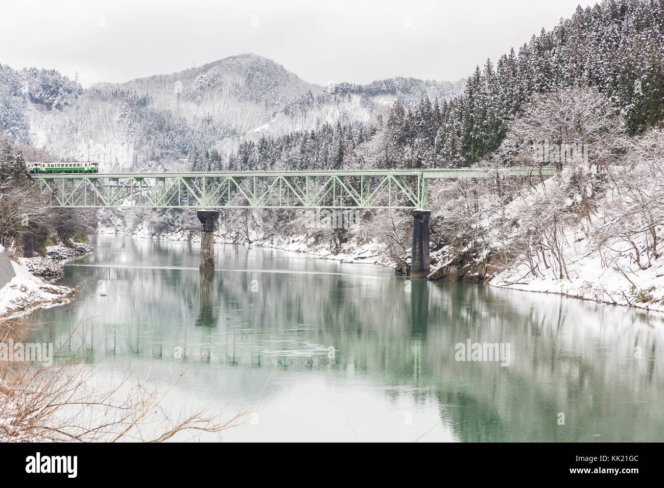 Train in Winter landscape snow on bridge Stock Photo - Alamy