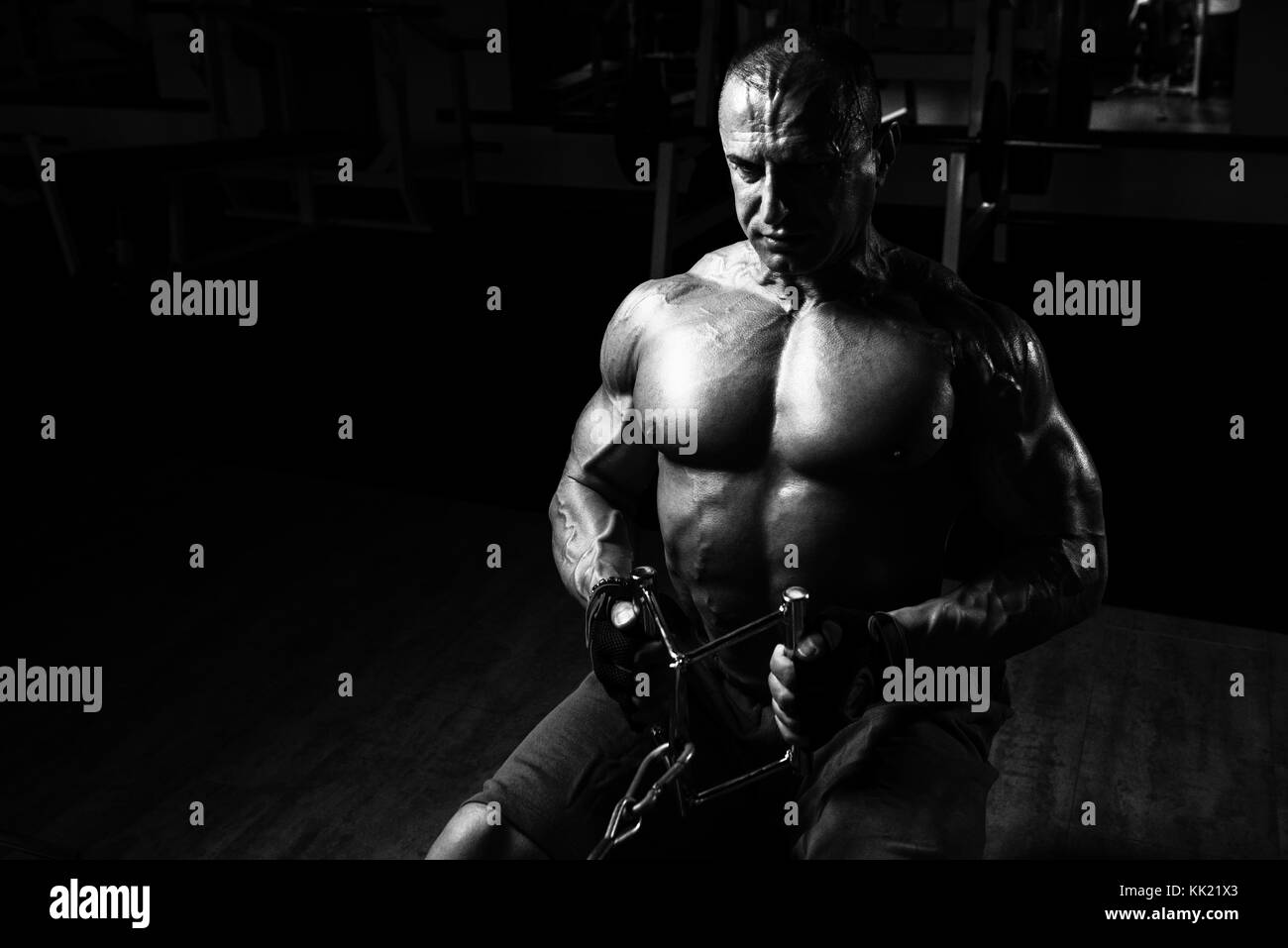 Handsome Bodybuilder Doing Heavy Weight Exercise For Back On Machine ...