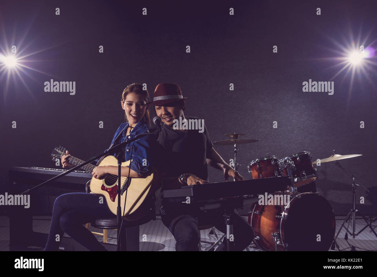 Musician duo band singing a song and playing music instrument with ...