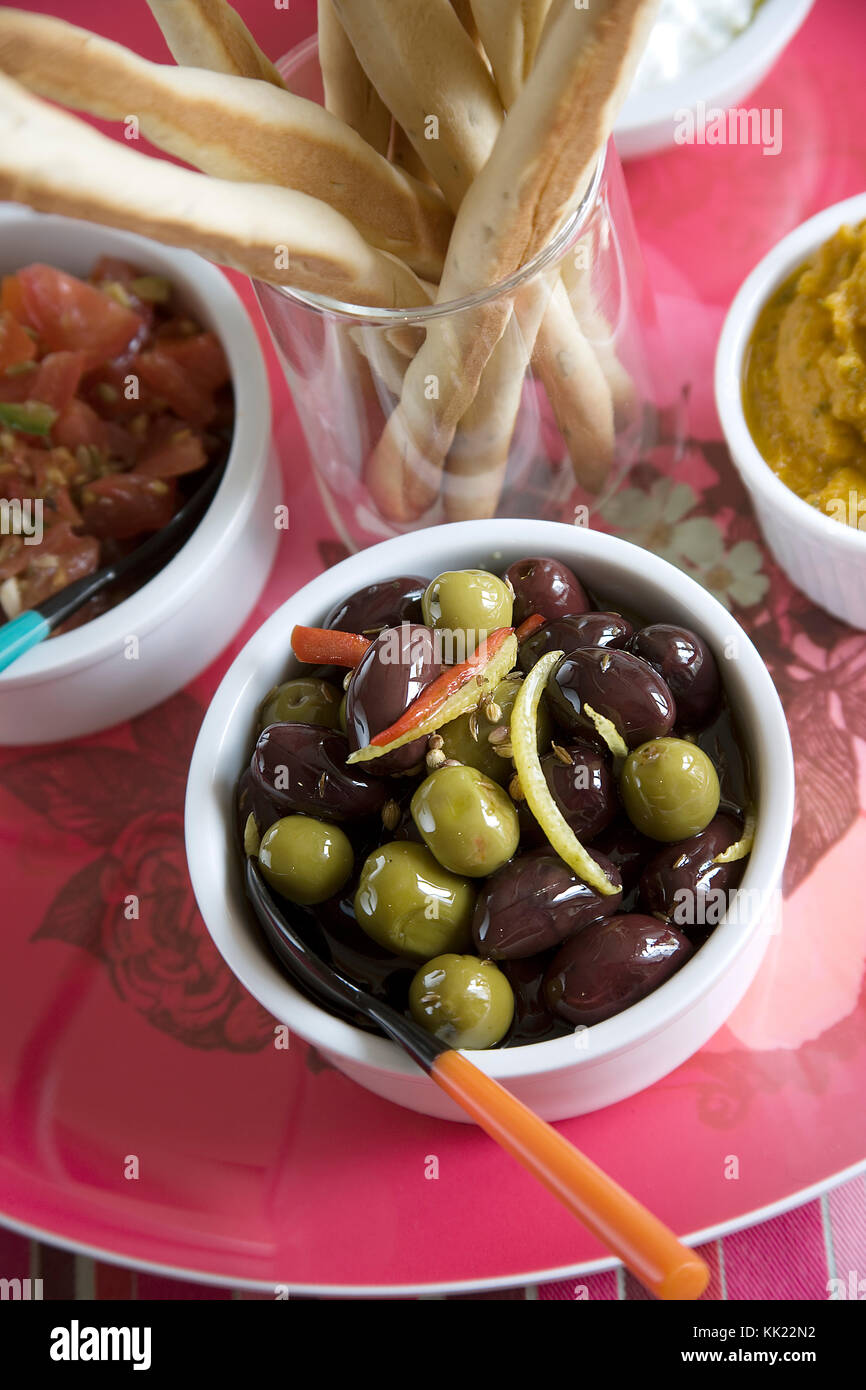 Mixed olives with sliced lemon and red chilli hi-res stock photography ...