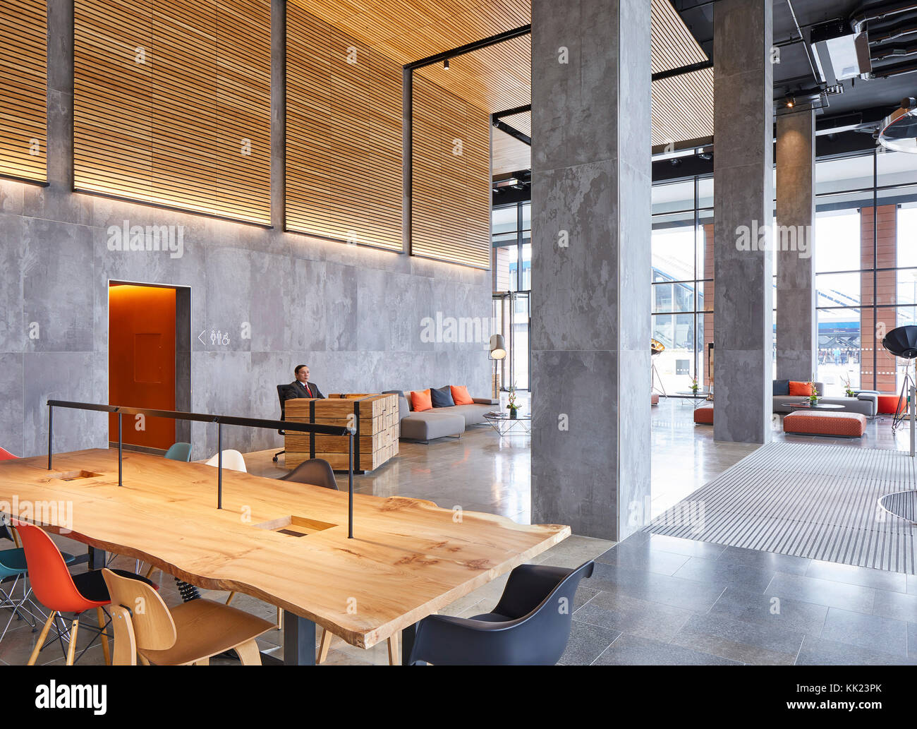 Double-height foyer with communal table and reception. Thames Tower ...