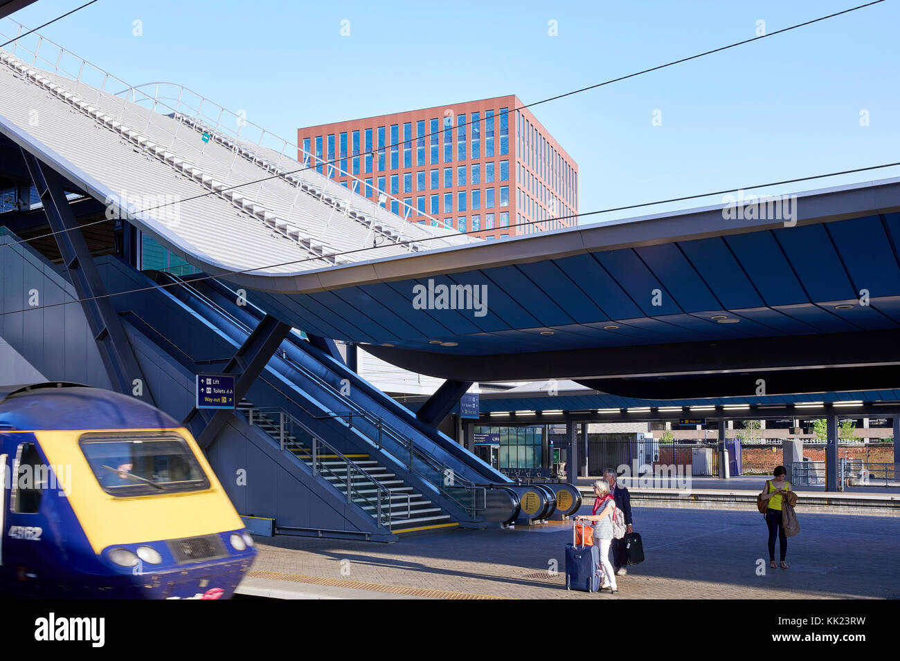 Distant view from station platform towards terracotta clad tower ...
