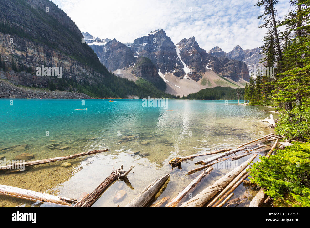 Beautiful turquoise waters of the Moraine lake with snow-covered peaks ...