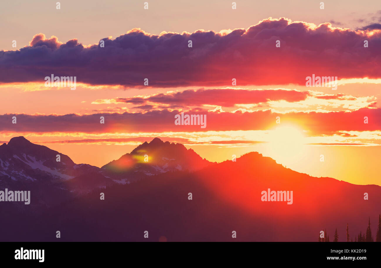 Sunset in mountains Stock Photo - Alamy