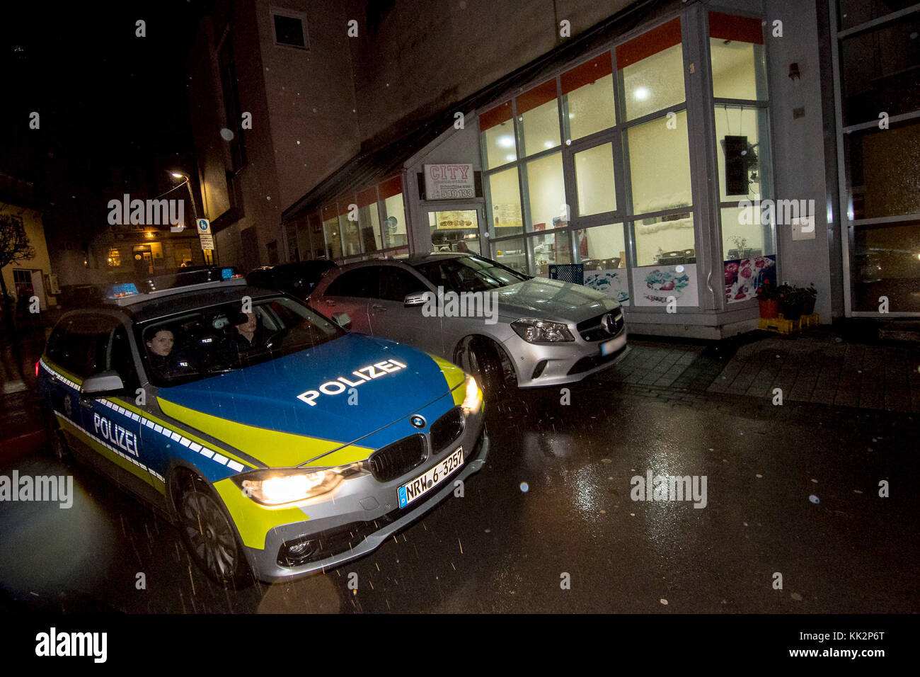 A police vehicle on patrol pulling up to a kebab diner in Altena ...