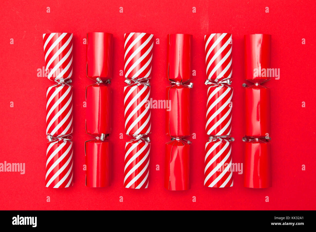 Christmas crackers on a red background Stock Photo - Alamy