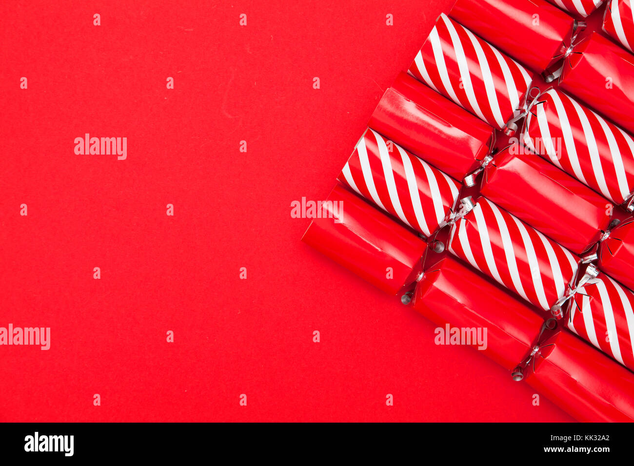 Christmas crackers on a red background Stock Photo - Alamy