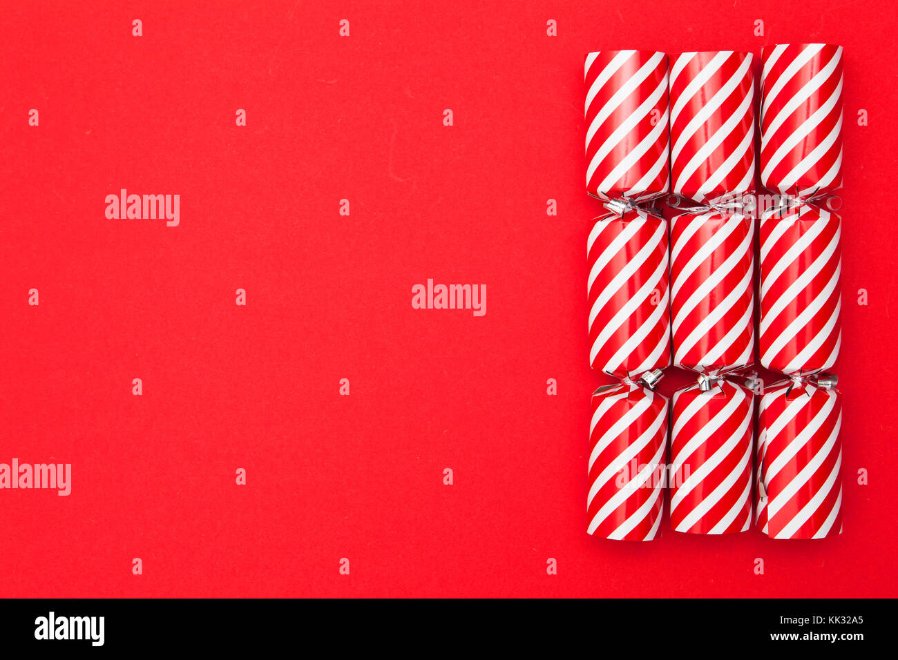 Christmas crackers on a red background Stock Photo - Alamy
