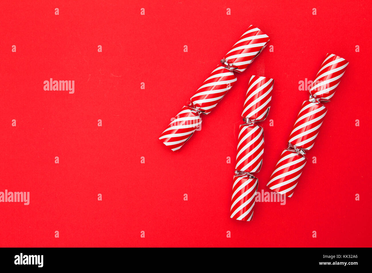 Christmas crackers on a red background Stock Photo - Alamy