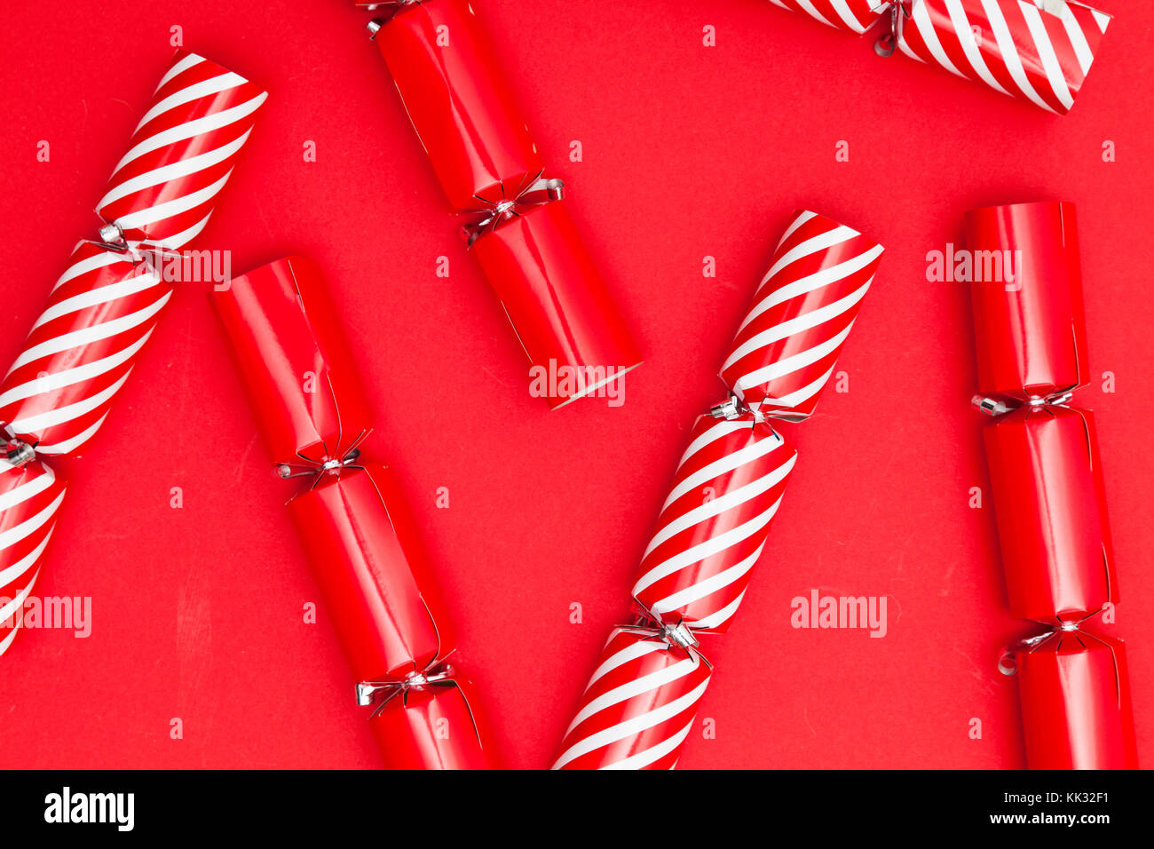Christmas crackers on a red background Stock Photo - Alamy