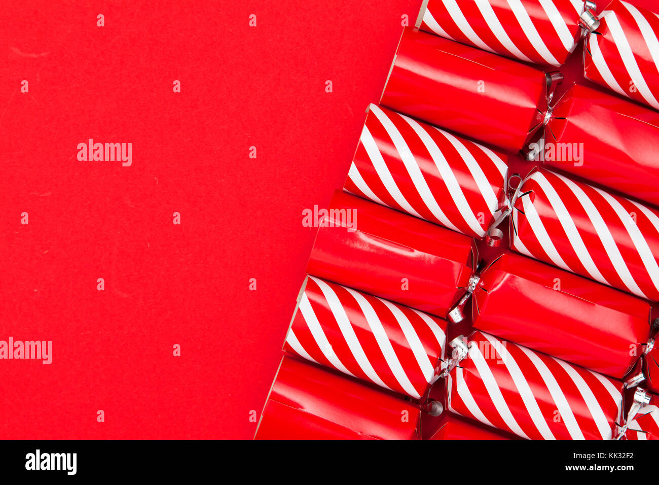 Christmas crackers on a red background Stock Photo - Alamy