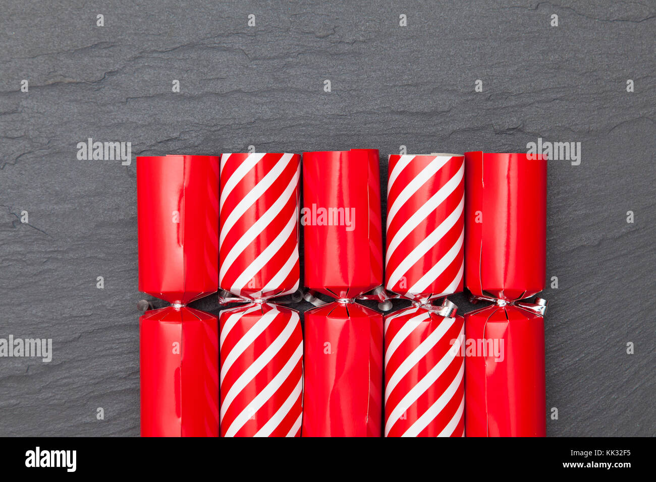Christmas crackers on a slate background crackers Stock Photo - Alamy