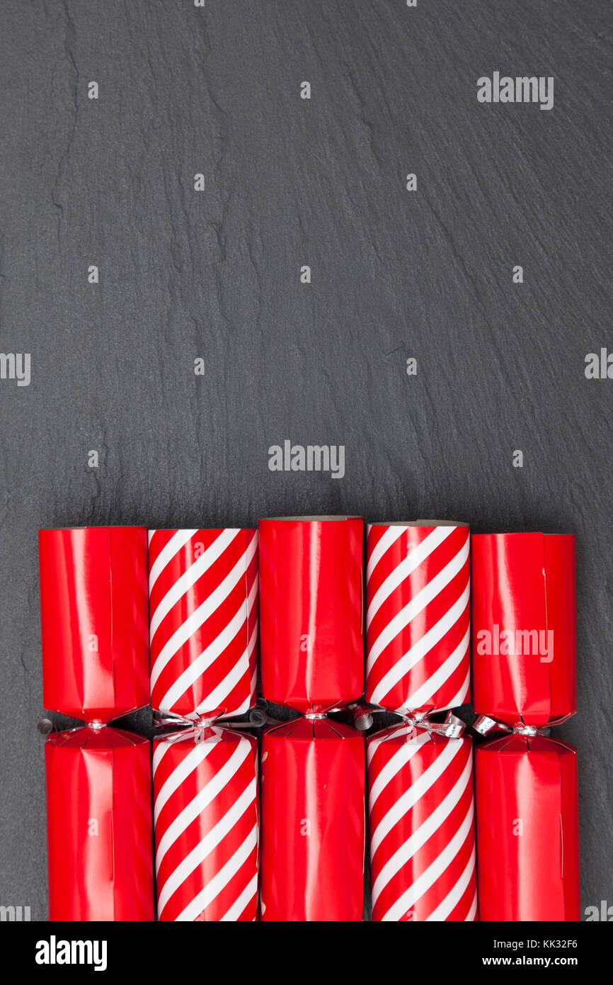 Christmas crackers on a slate background crackers Stock Photo - Alamy