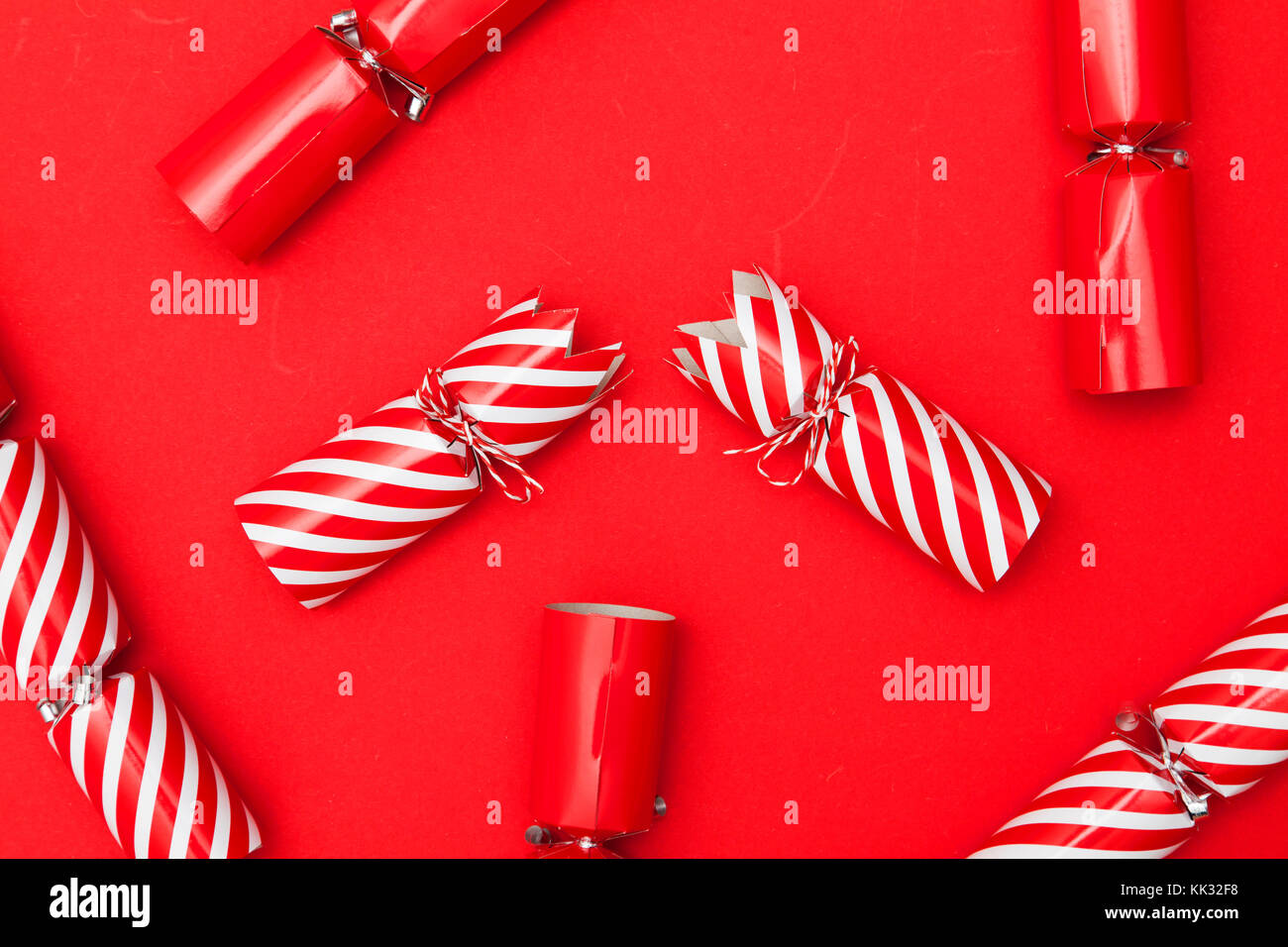 Christmas crackers on a red background Stock Photo - Alamy
