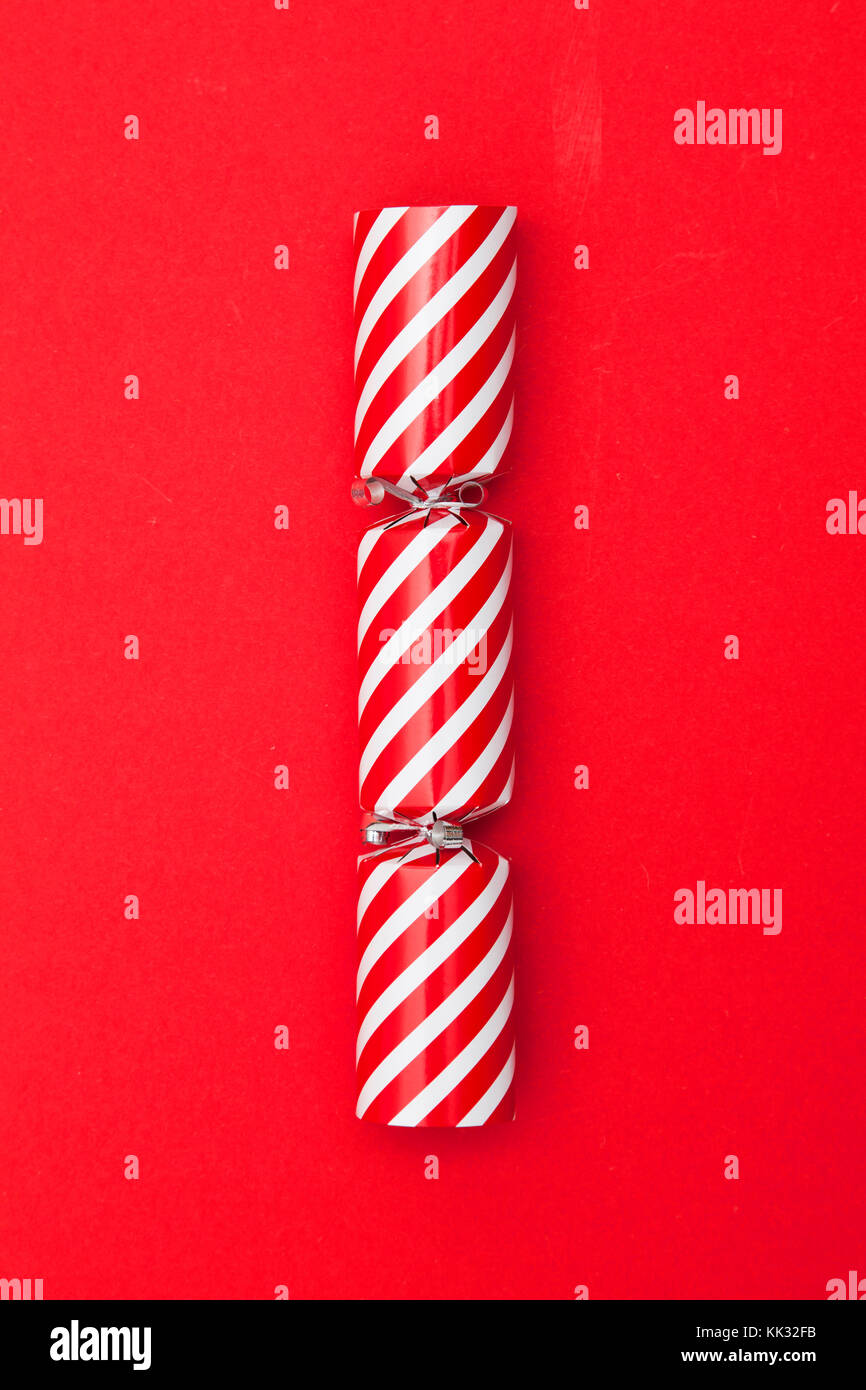 Christmas crackers on a red background Stock Photo - Alamy