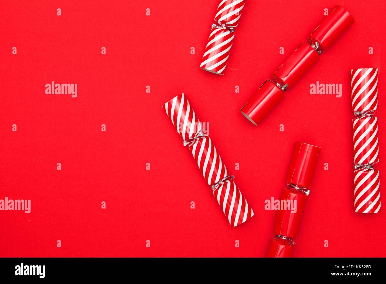 Christmas crackers on a red background Stock Photo - Alamy