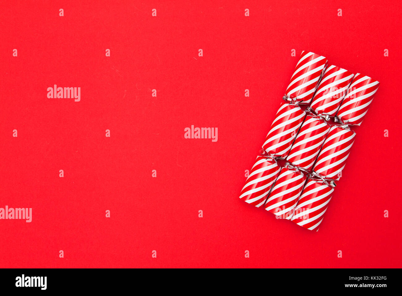 Christmas crackers on a red background Stock Photo - Alamy