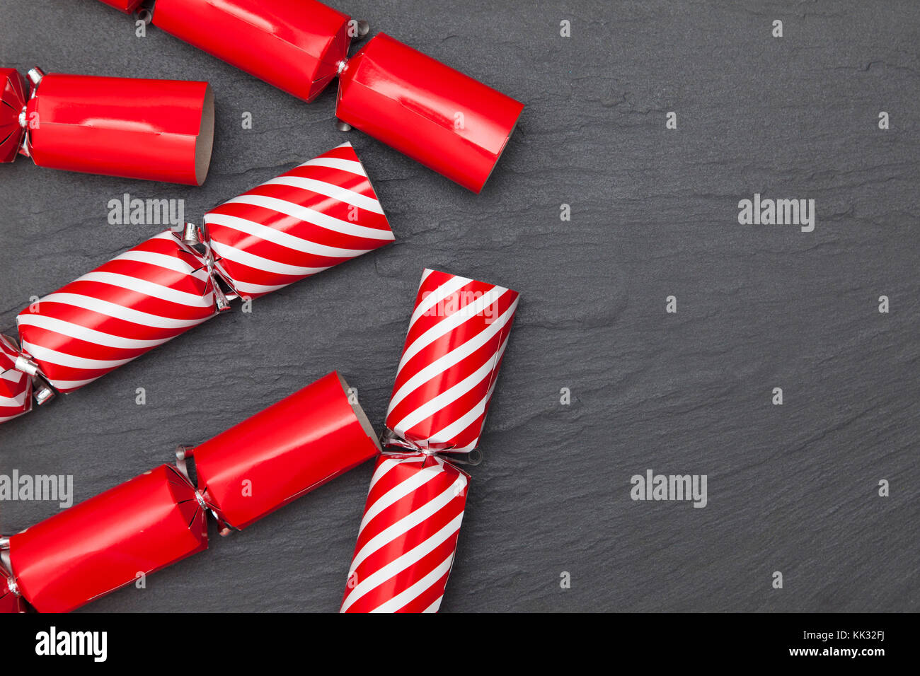 Christmas crackers on a slate background crackers Stock Photo - Alamy