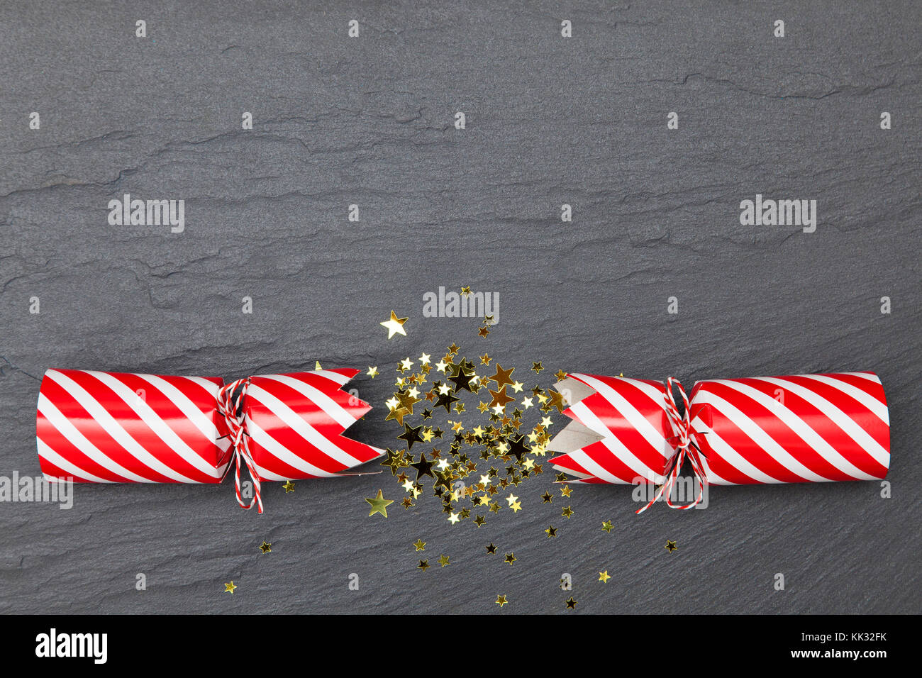 Christmas crackers on a slate background crackers Stock Photo - Alamy