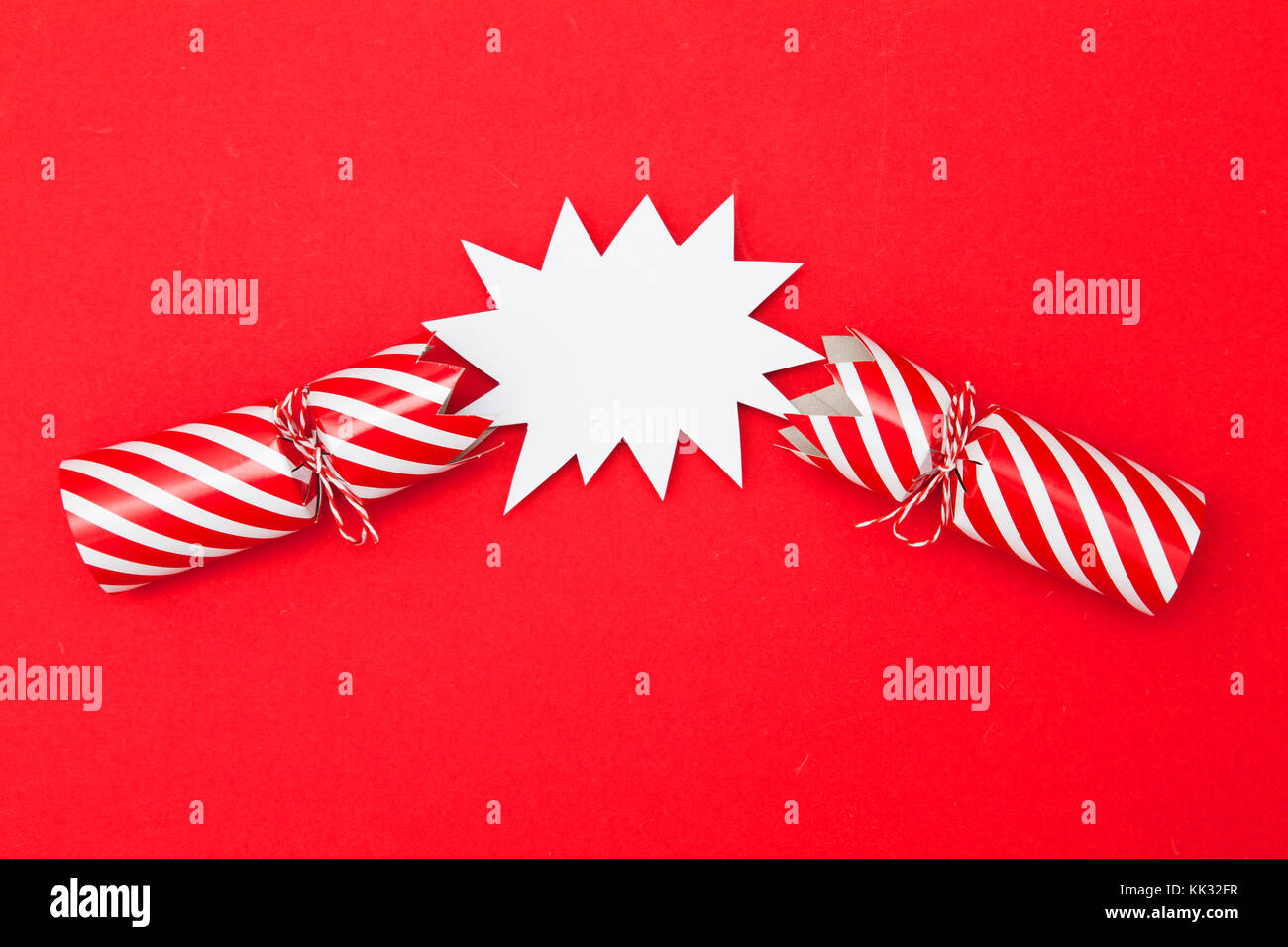 Popped Christmas crackers on a red background Stock Photo - Alamy