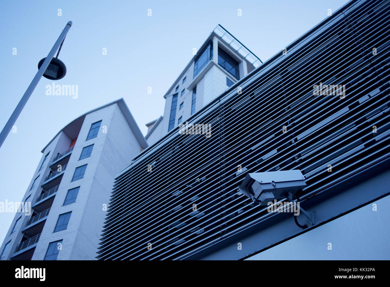Hi-rise building at dusk and CCTV camera mounted Stock Photo - Alamy