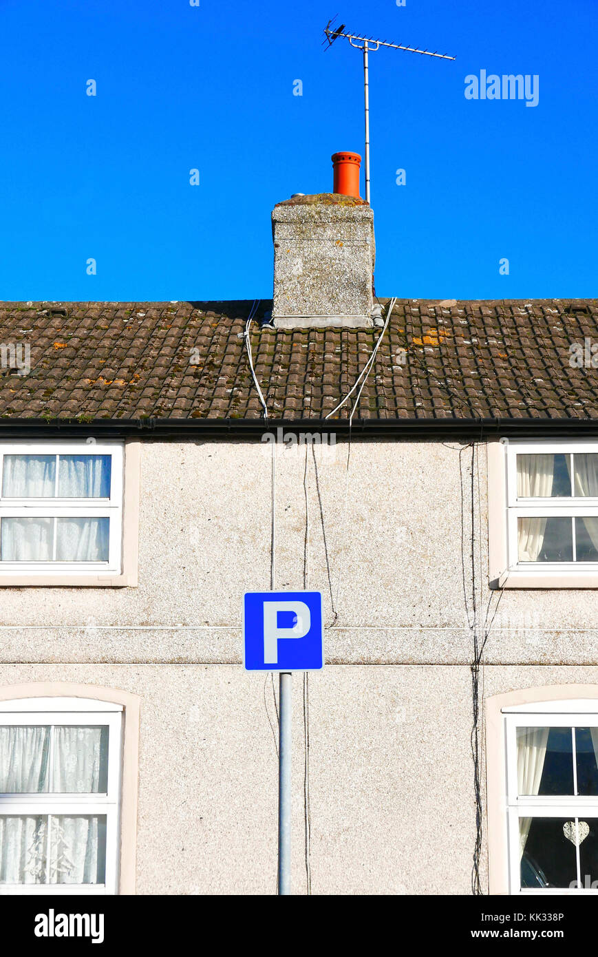 Row of small cottages with blue square parking sign at front Stock ...
