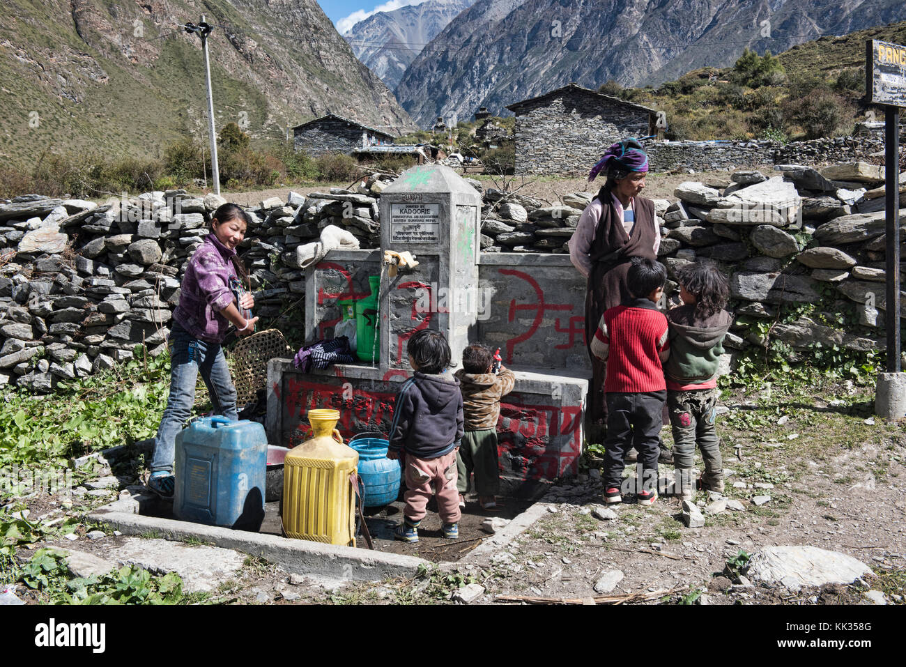 Community water tap in the remote Tsum Valley, Nepal Stock Photo - Alamy