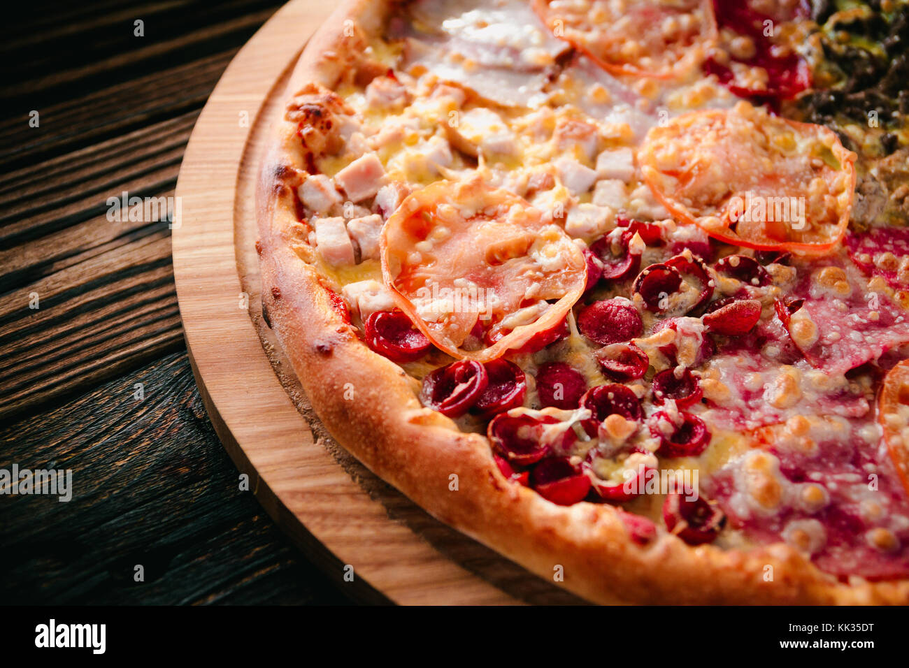 Cooked pizza on a dark wooden surface Stock Photo - Alamy