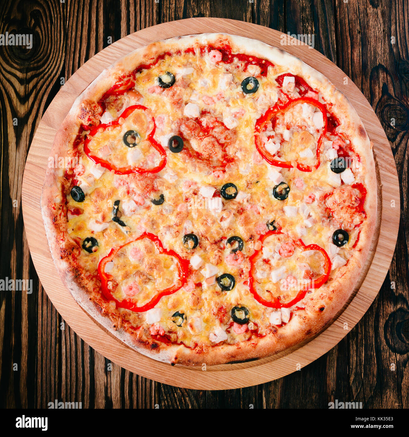 Cooked pizza on a dark wooden surface Stock Photo - Alamy