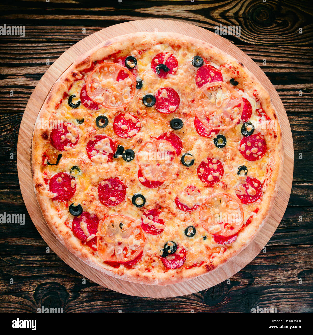 Cooked pizza on a dark wooden surface Stock Photo - Alamy