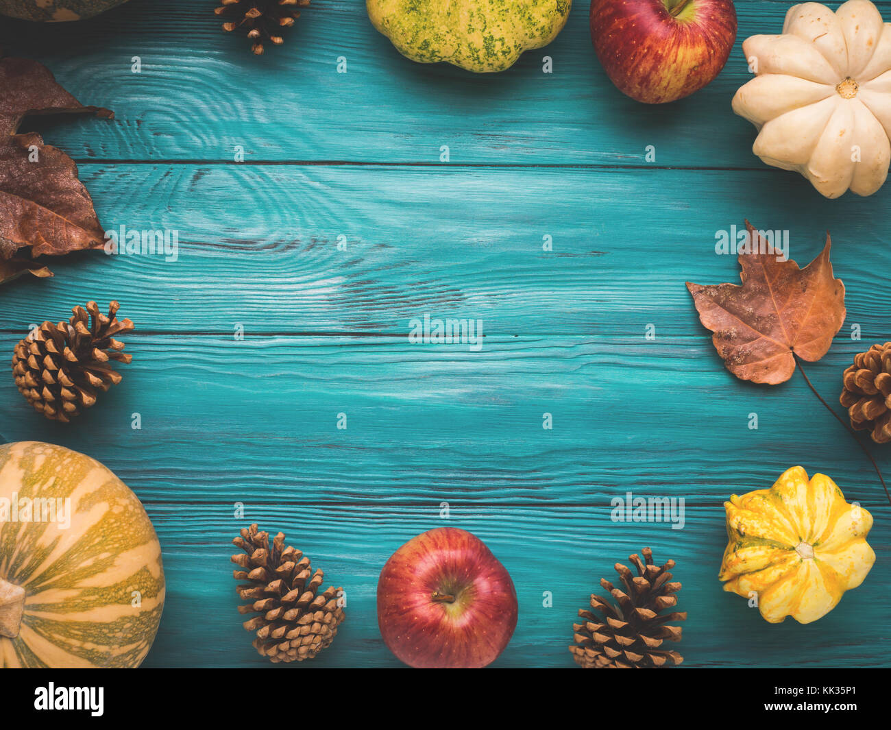 Moody green autumn background with pumpkin, apples, yellow leaves. Fall ...