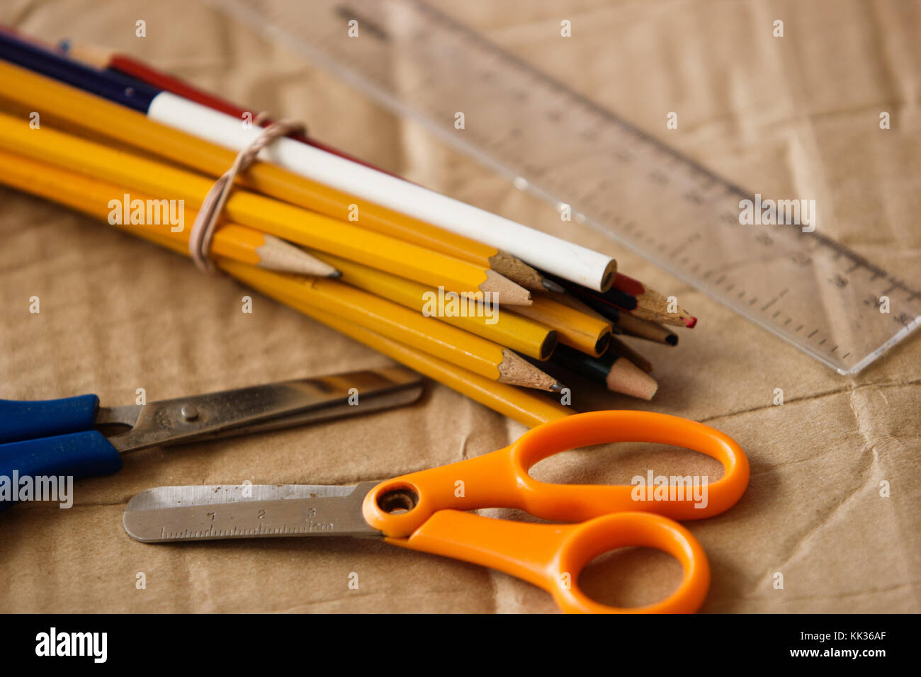 orange scissors, blue scissors and pack of wood yellow pencils with ...
