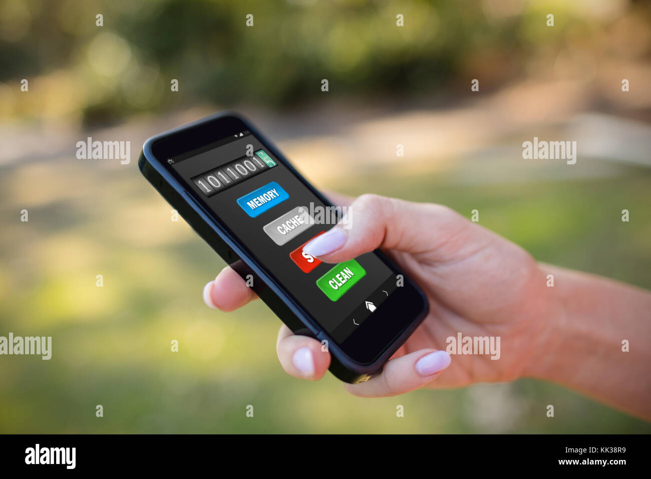 Mobile display with memory cleaner against cropped hands of woman using ...