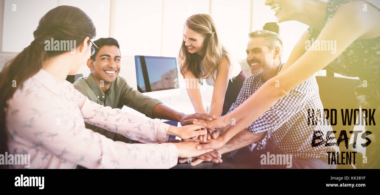 Hard work beats talent against happy business colleagues stacking hands ...