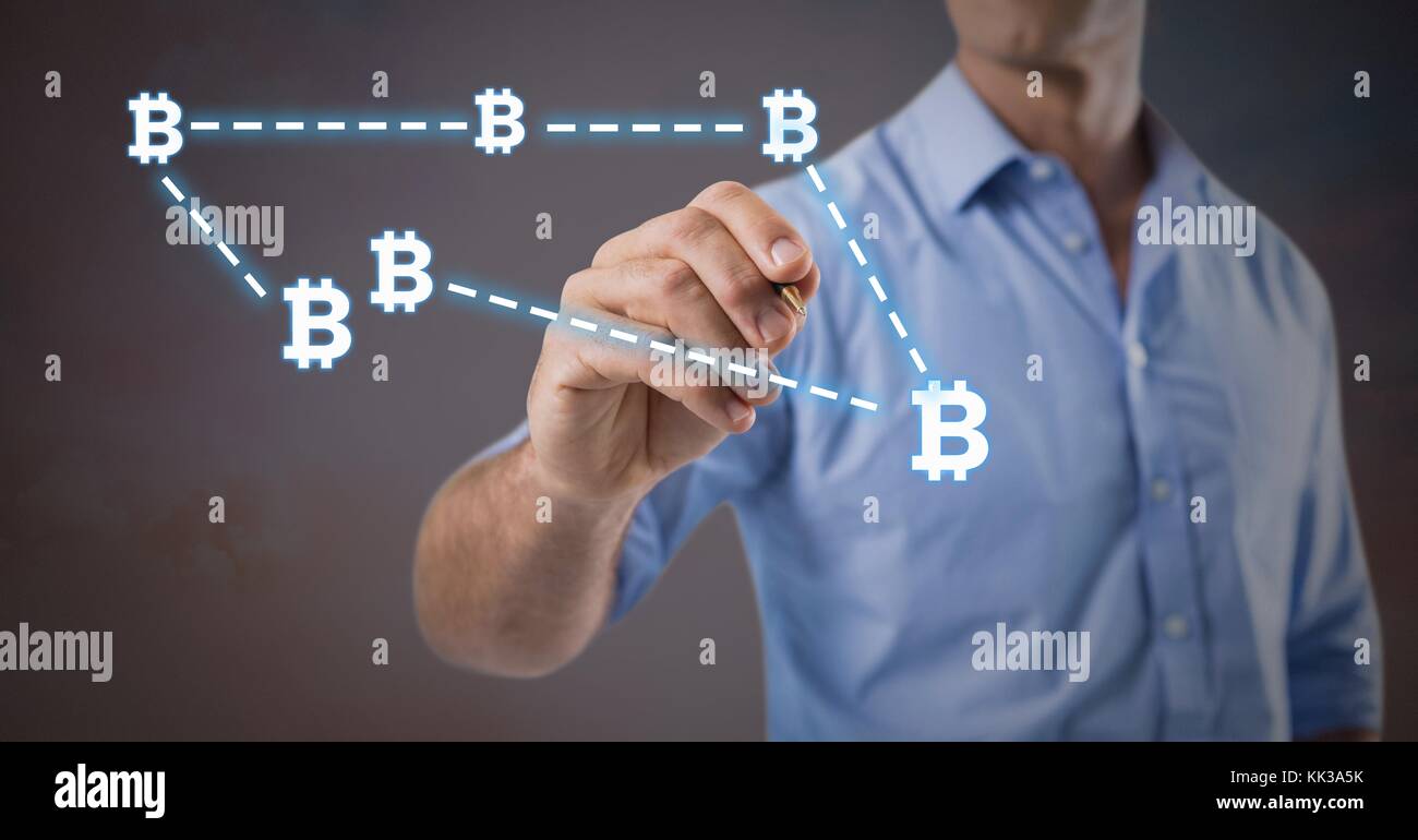 Digital composite of Businessman holding pen with bitcoin graphic icons ...