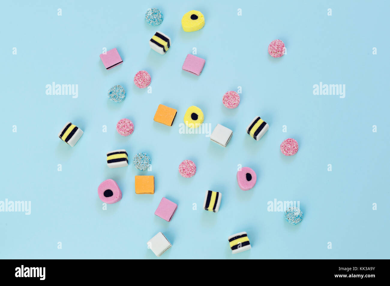 Colored candy scattered on the blue background Stock Photo - Alamy