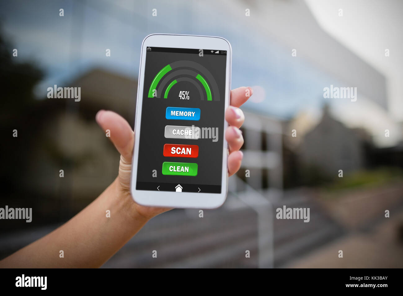 Mobile display with memory cleaner against woman holding mobile phone ...