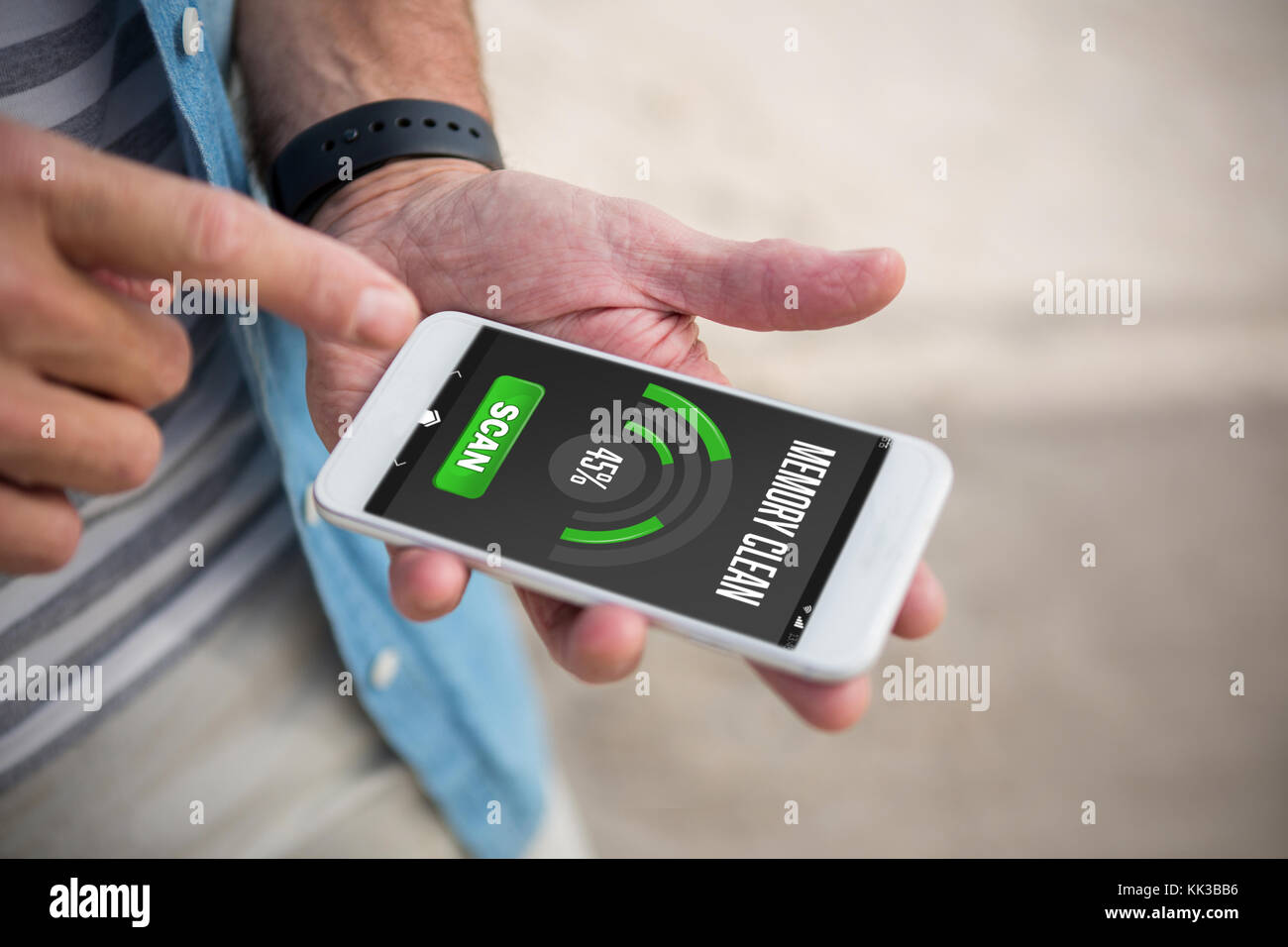 Mobile display with memory cleaner against midsection of man using ...