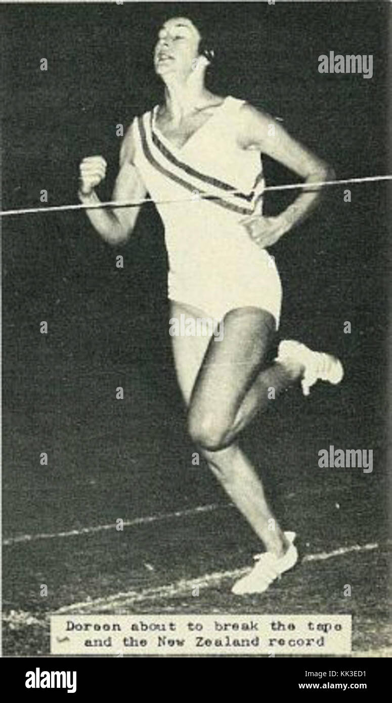 Doreen about to break the tape and the New Zealand record Stock Photo ...