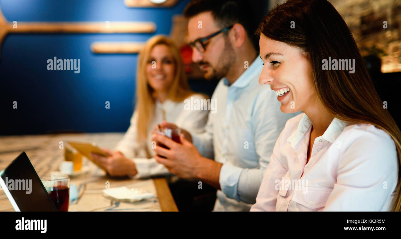 Happy colleagues from work socializing in restaurant Stock Photo - Alamy