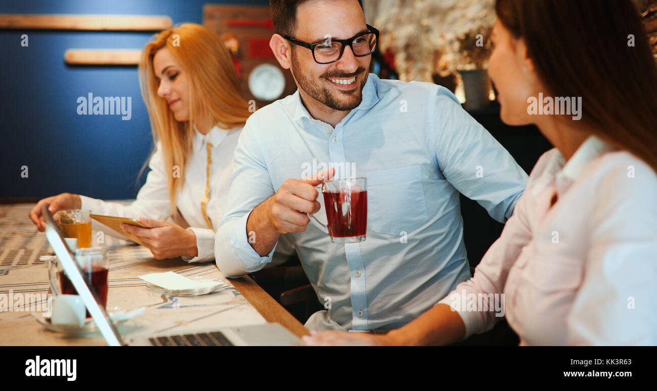 Happy colleagues from work socializing in restaurant Stock Photo - Alamy