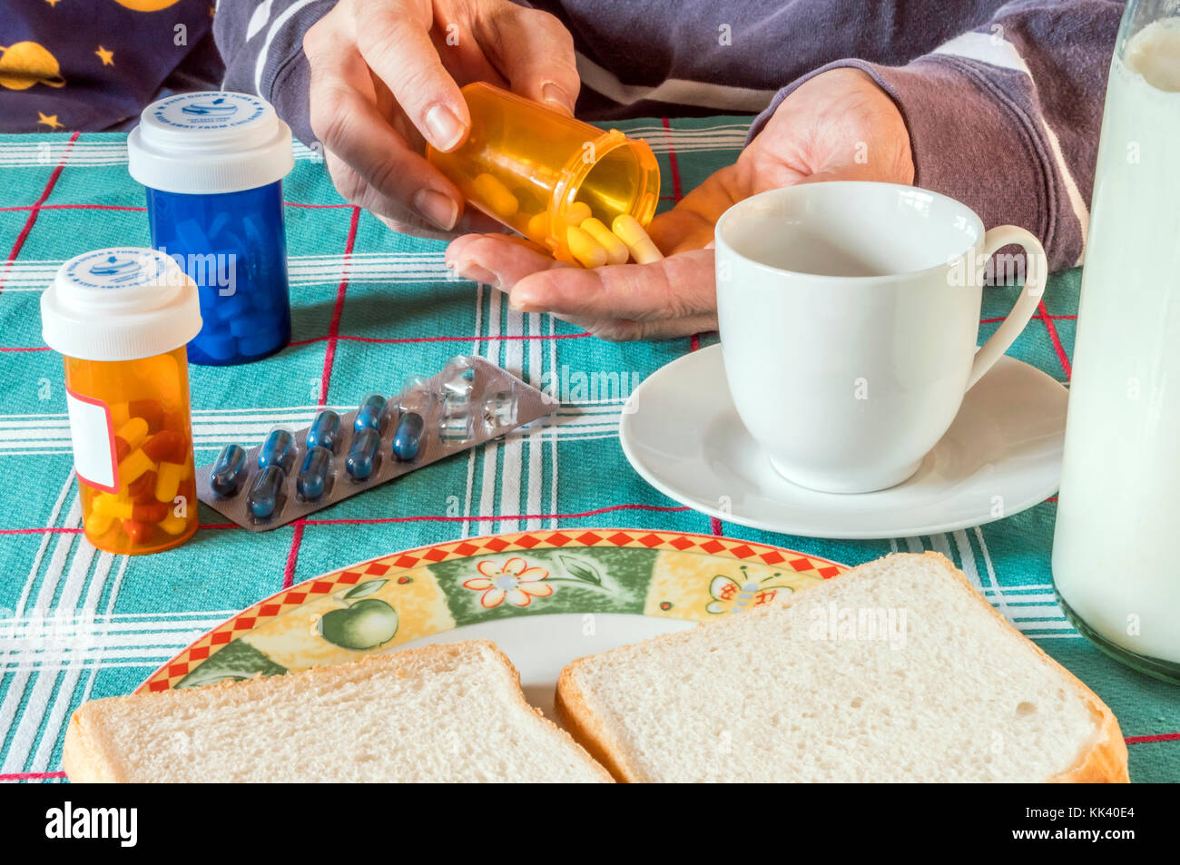 Person takes medication during breakfast, conceptual image Stock Photo ...