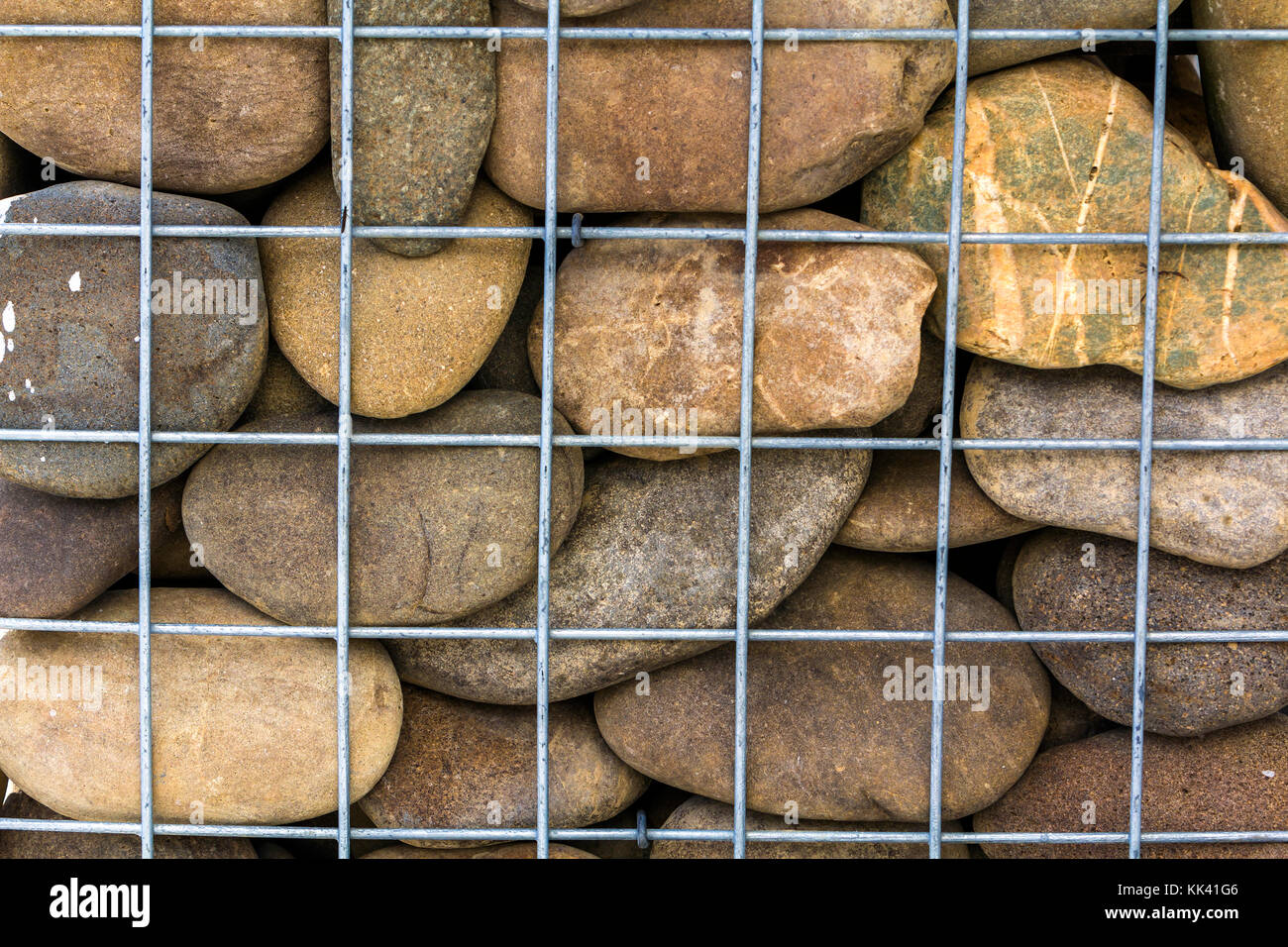 Abstract background of stones behind steel bars Stock Photo - Alamy