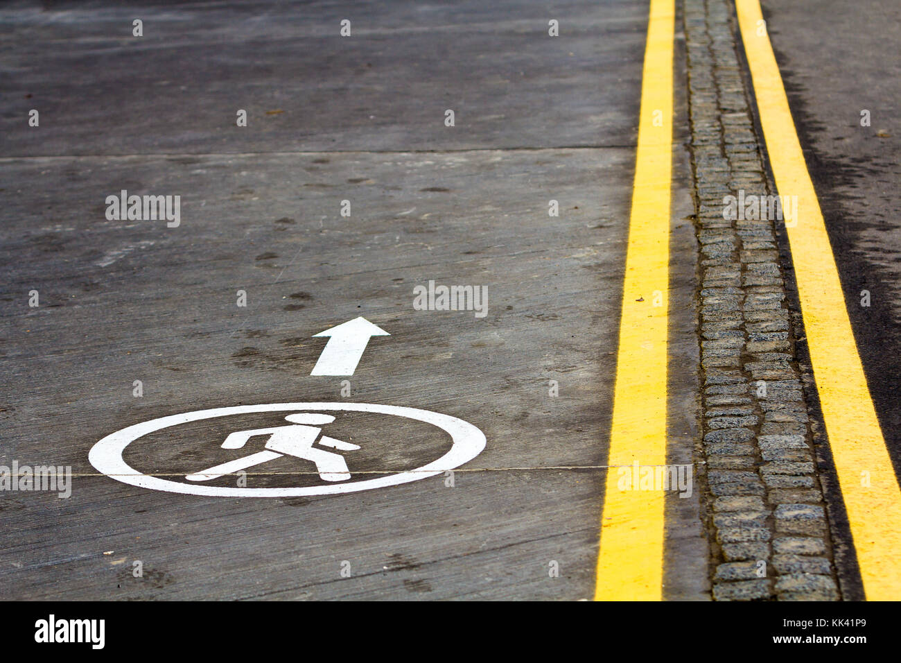 Walk way sign on the asphalt road surface Stock Photo - Alamy