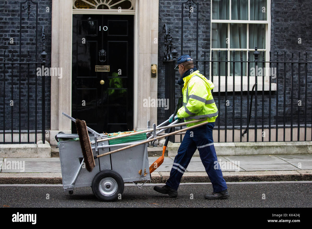 London, UK. 21st November, 2017. A street cleaner passes 10 Downing ...