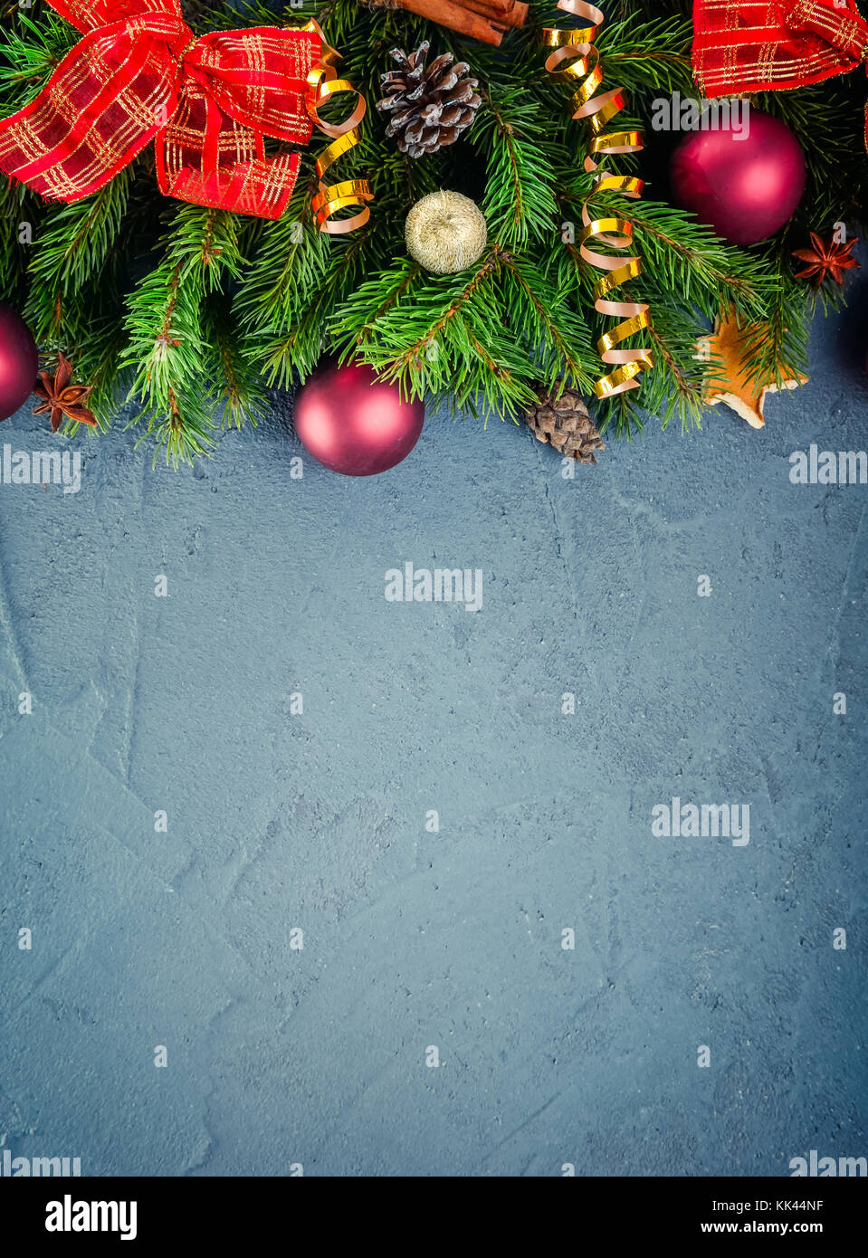 Dark gray christmas background with fir branches and spices on a slate ...