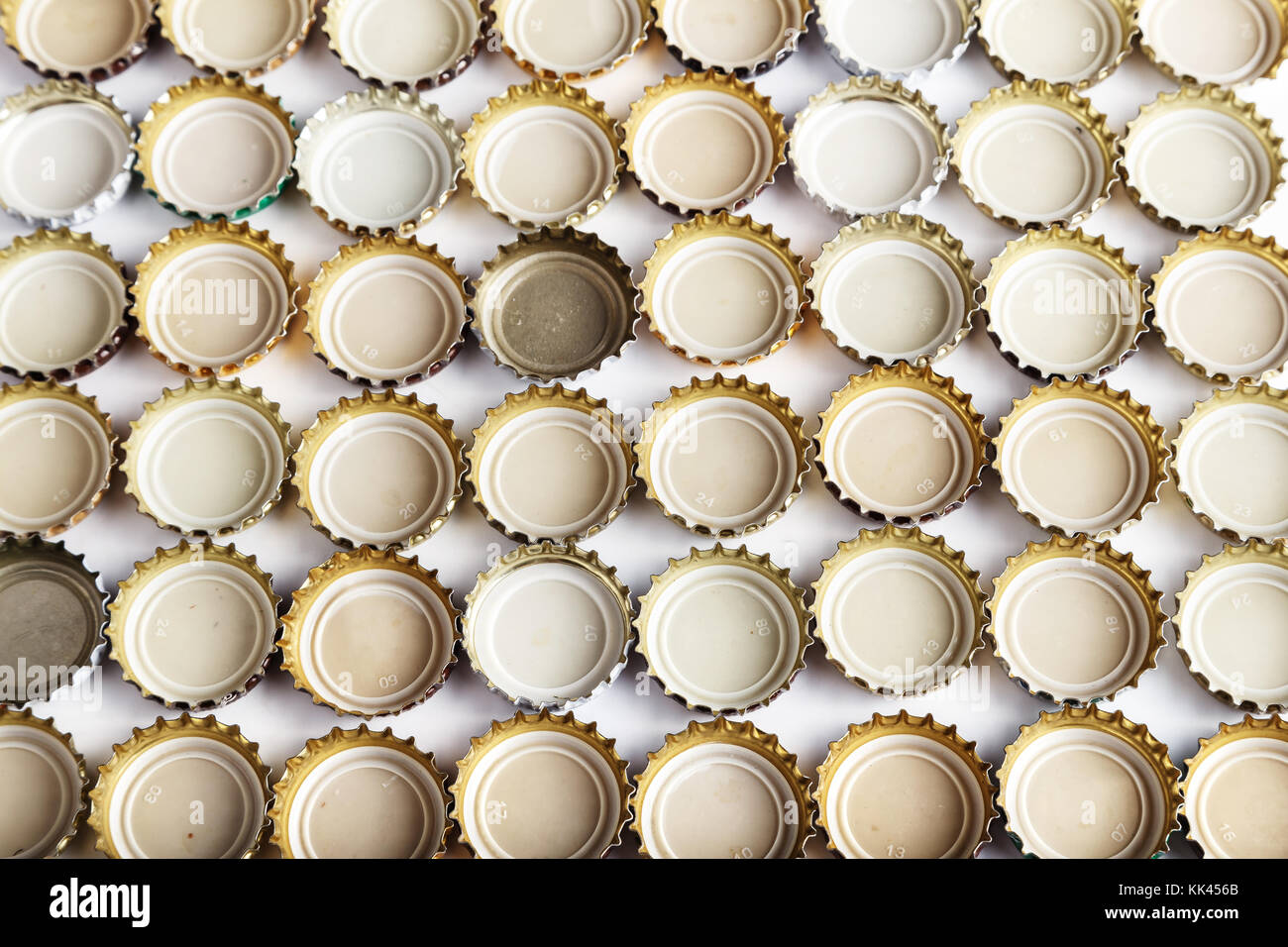 many inverted covers of beer are laid out in rows, the background Stock ...