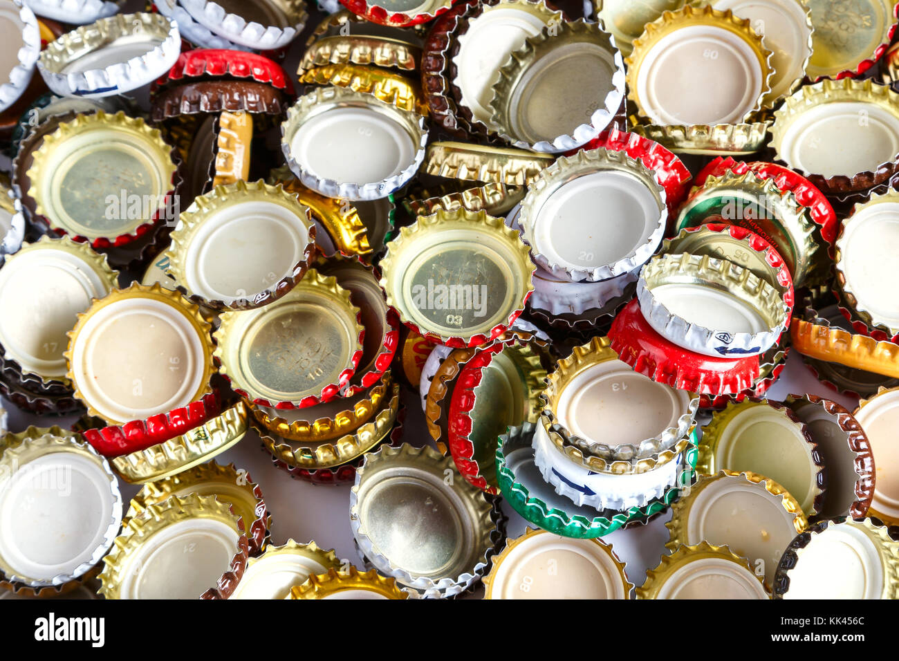 many inverted covers of beer are laid out in rows, the background Stock ...