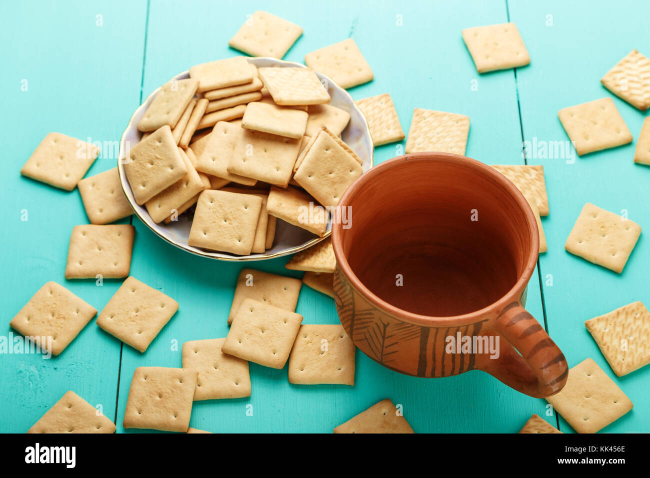 Empty clay cup and crackers scattered on the table Stock Photo - Alamy
